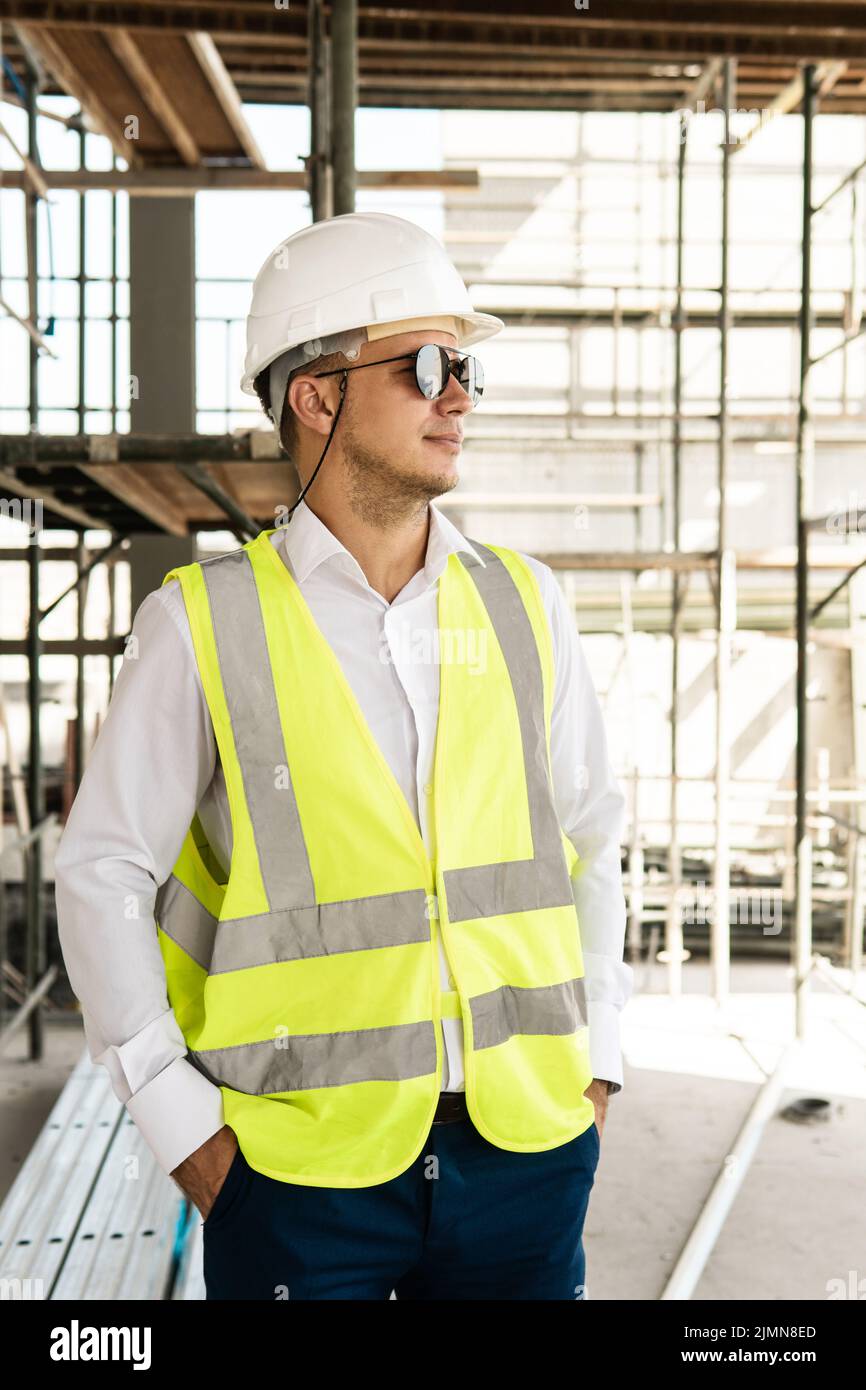 Architect wearing safety vest on a construction site Stock Photo - Alamy