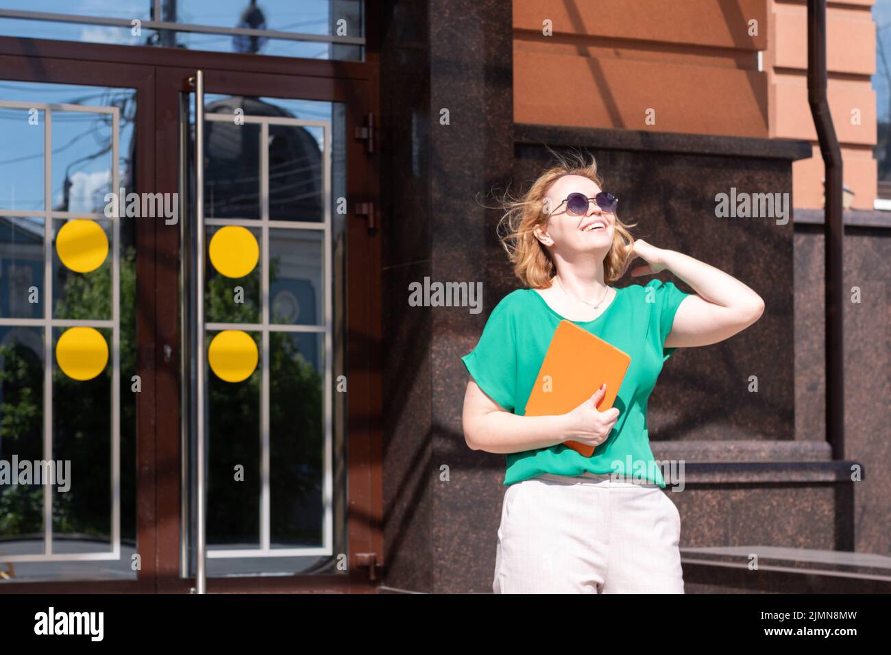 Woman looking around door hi-res stock photography and images - Alamy