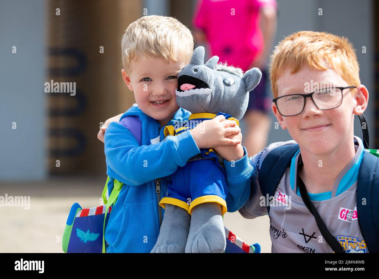 A young Leeds Rhinos supporter holds his Ronnie the Rhino plush teddy ...