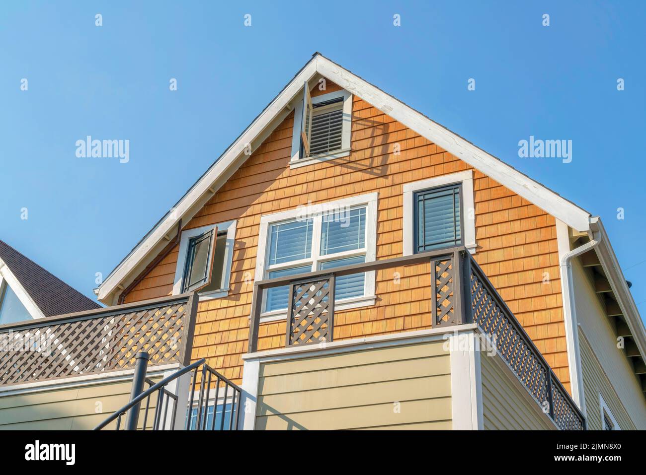 Low angle view of a house with wood shingles wall sidings and side ...