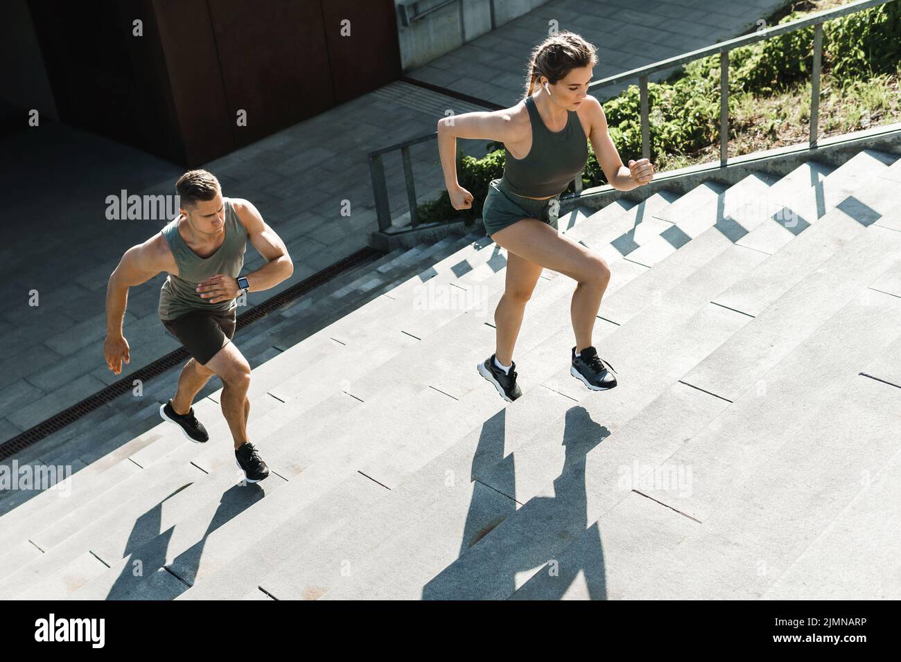 Sportive couple during workout stair running outdoors Stock Photo - Alamy