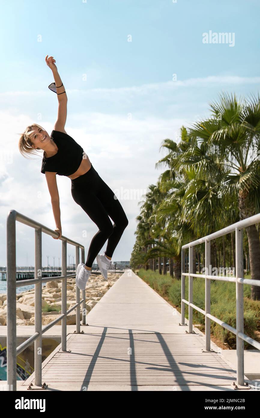 Sportive girl jumping outdoors hi-res stock photography and images - Alamy