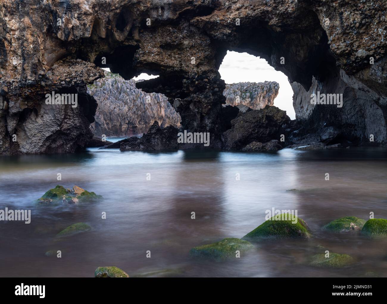 Detail view of the caves of the Cuevas del Mar beach in Asturias Stock ...