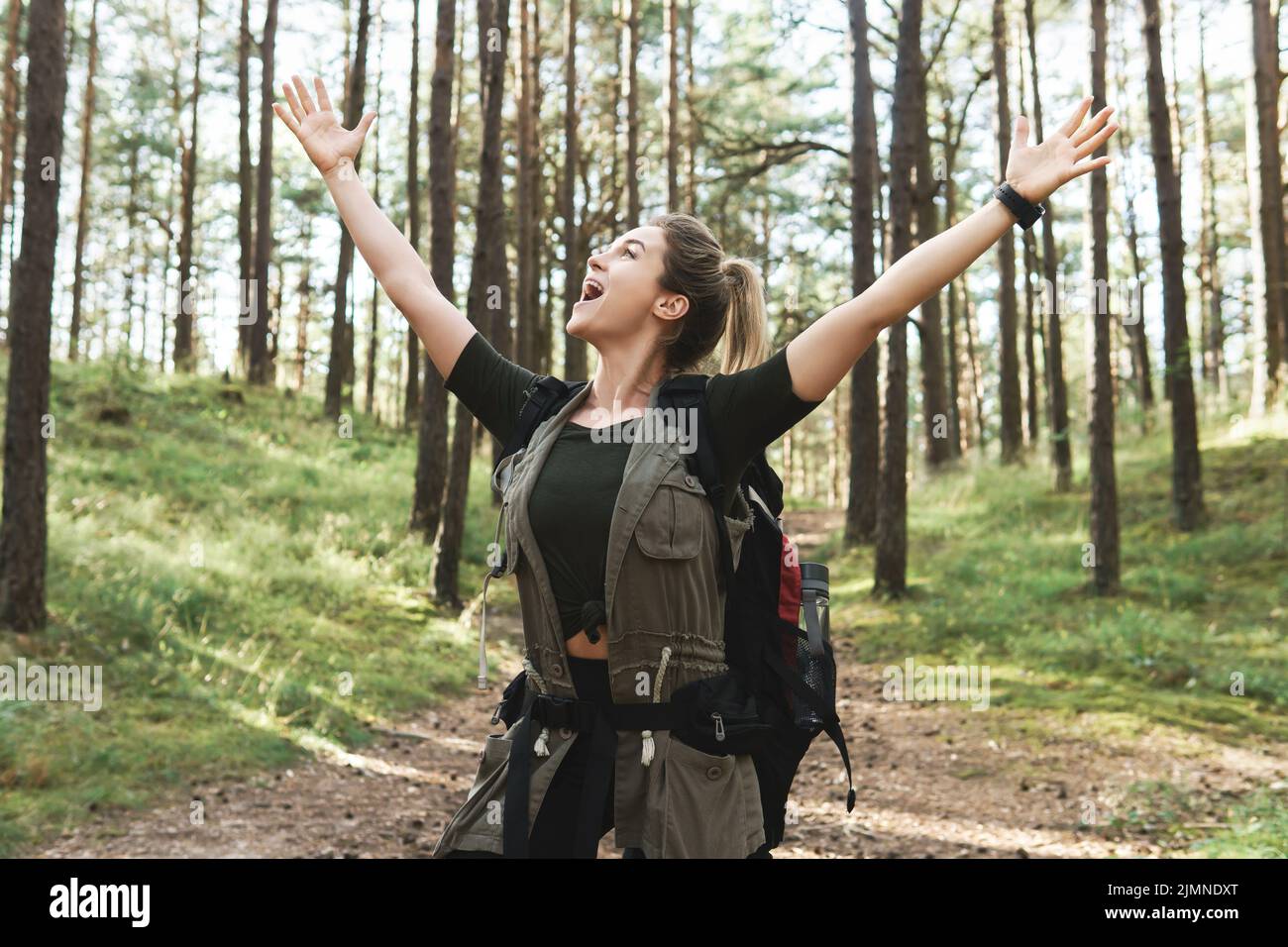 Female hiker with big backpack in green forest Stock Photo - Alamy