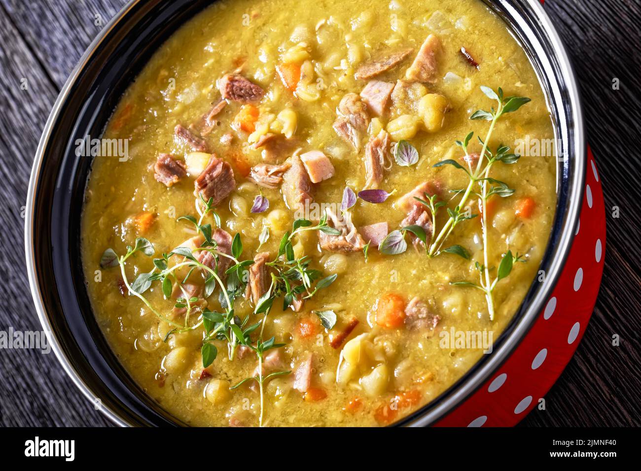 Finnish split pea soup Hernekeitto with pulled pork meat on red pot ...
