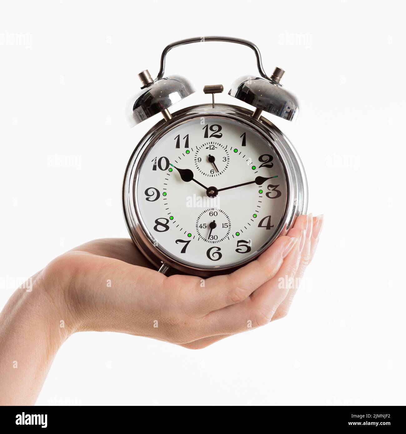 Hand holding clock hi-res stock photography and images - Alamy