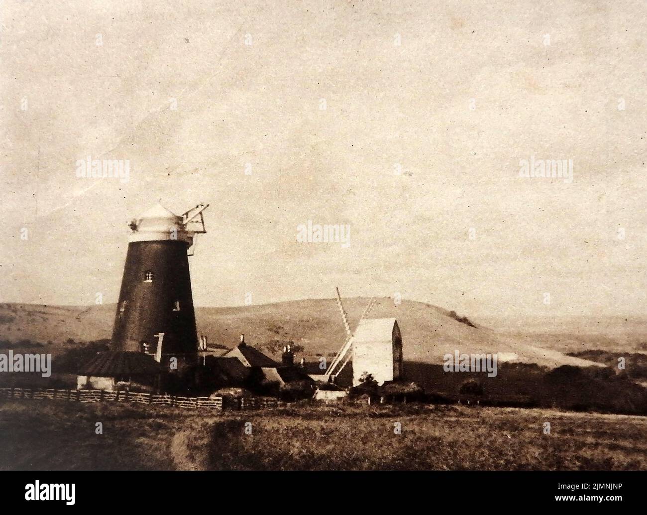 An old photograph showing two types of British windmills Stock Photo ...