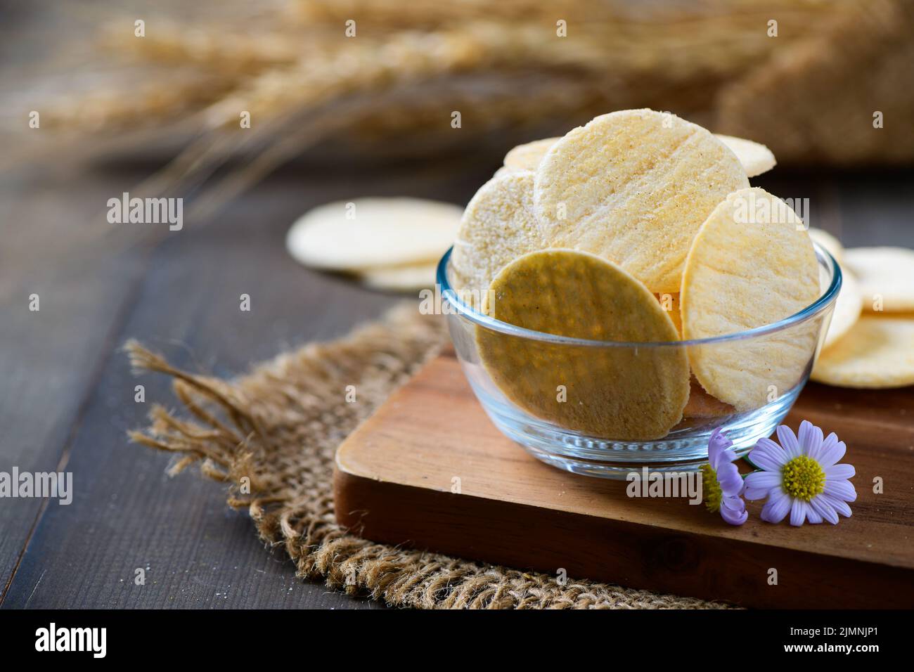 Round Crackers biscuits in glass cup and wood background, Dry cracker ...