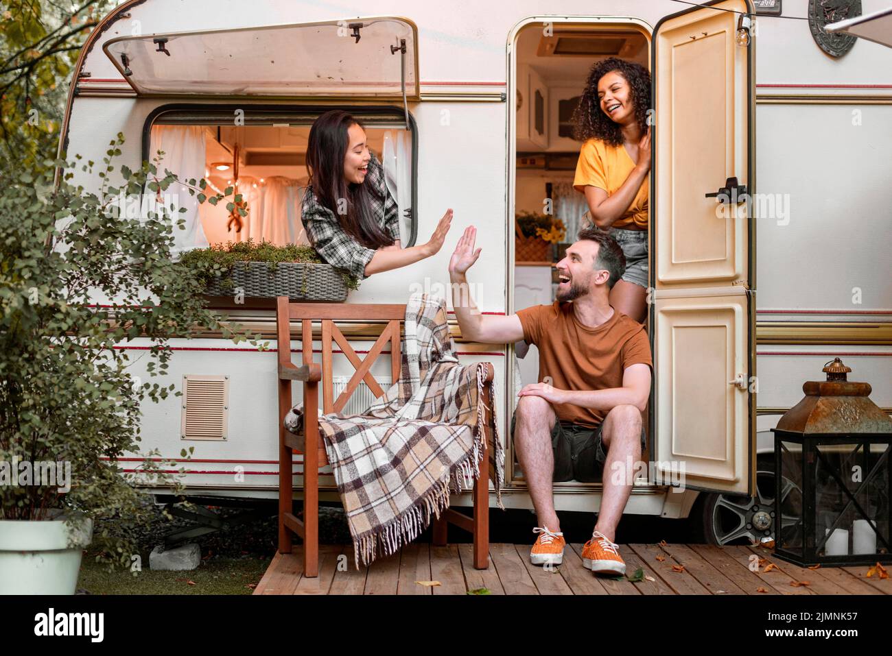 Happy friends van high five Stock Photo - Alamy