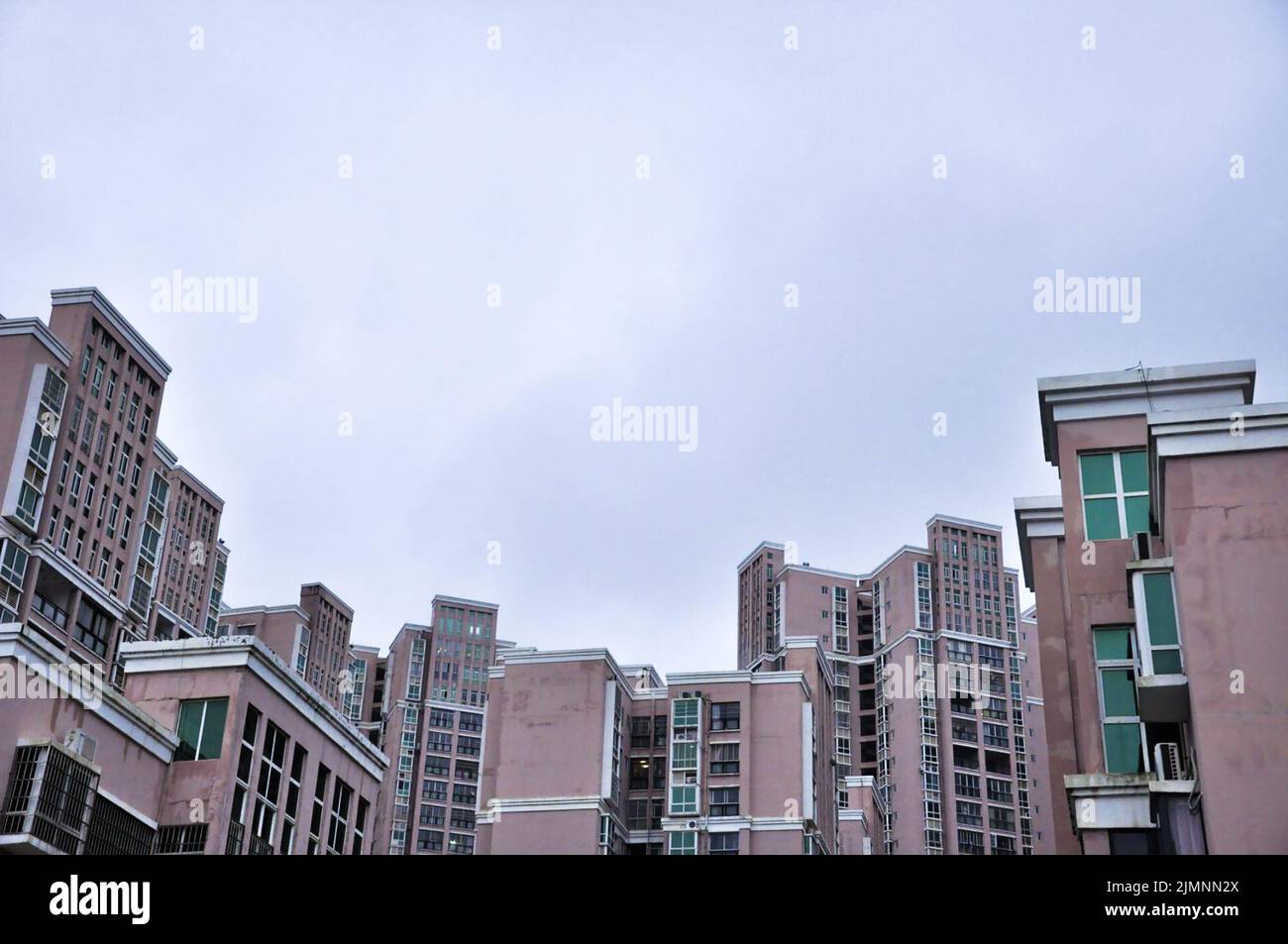 Residential multi-story buildings under a cloudy sky Stock Photo - Alamy