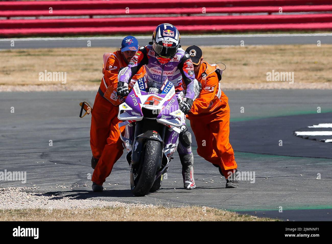 Johann Zarco is helped back on track by track stewards after crashing ...