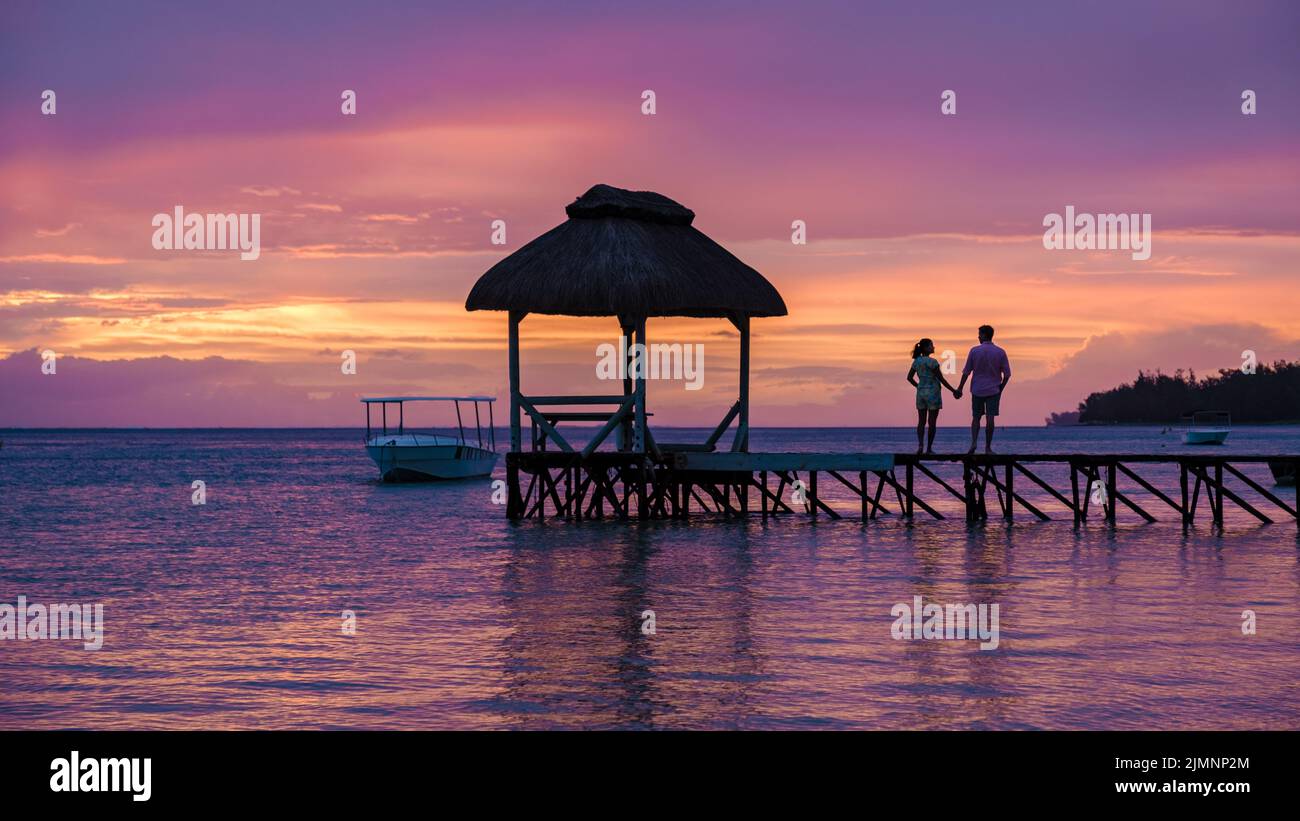 Swimming pool with beach chairs and lunch table at a luxury resort ...