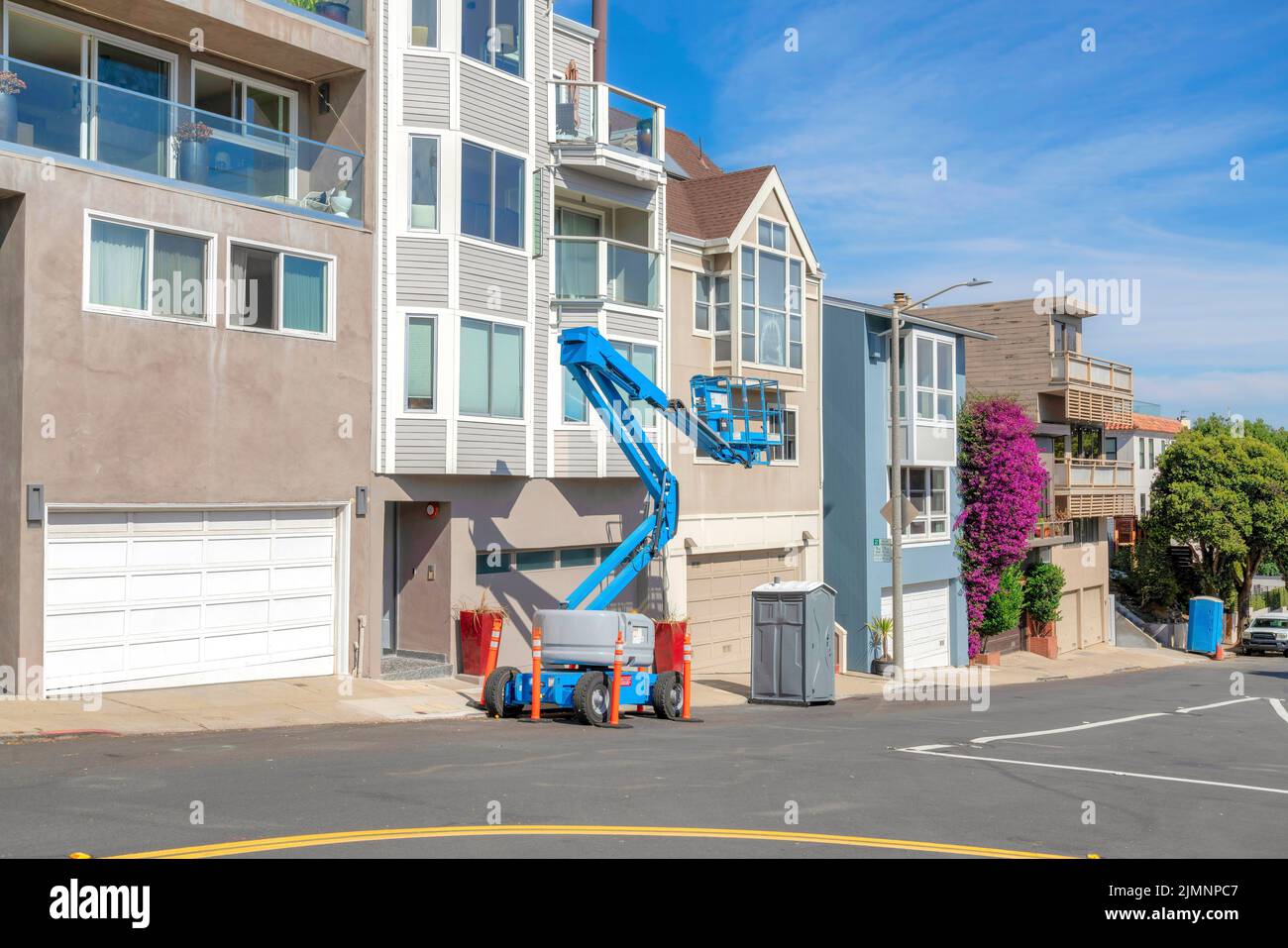 Row of complex houses in San Francisco, California with boom lifter at ...