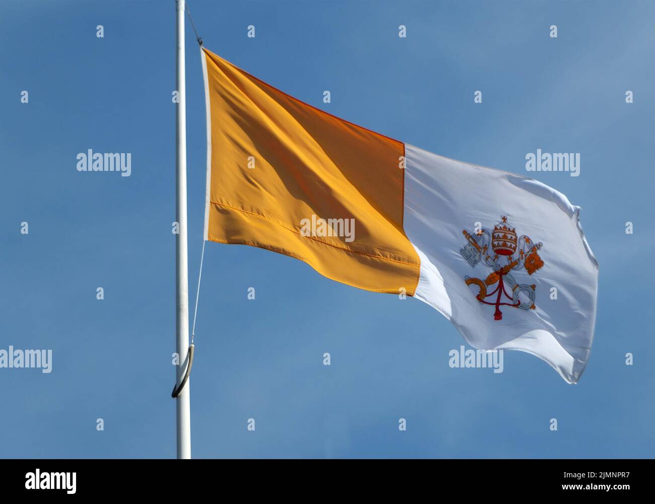 Vatican state flag flying against a bright blue sunlit sky Stock Photo ...