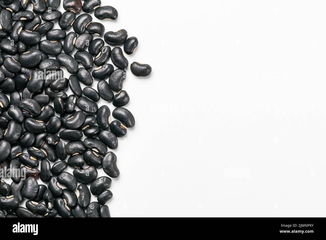 Top view of uncooked black beans on white background Stock Photo - Alamy