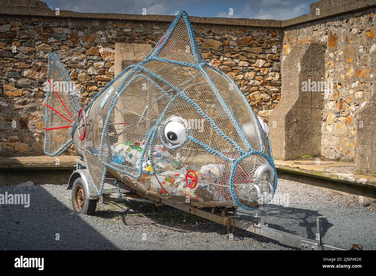 Dublin, Ireland, Aug 2019 Net container in fish shape with trash in it ...