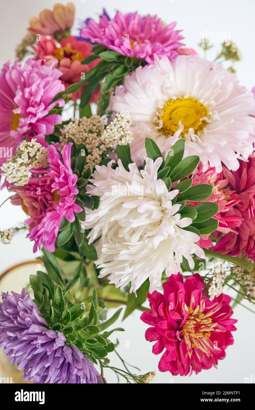 A bouquet of bright flowers on a light background Stock Photo - Alamy