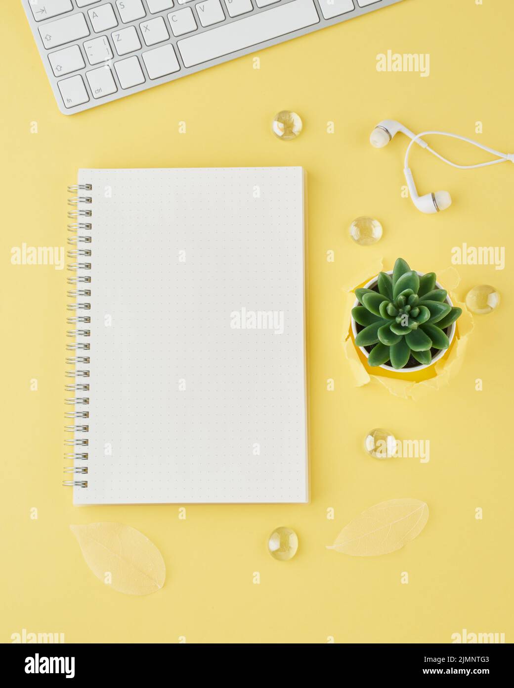 Blank notepad page in bullet journal on bright yellow office desktop ...