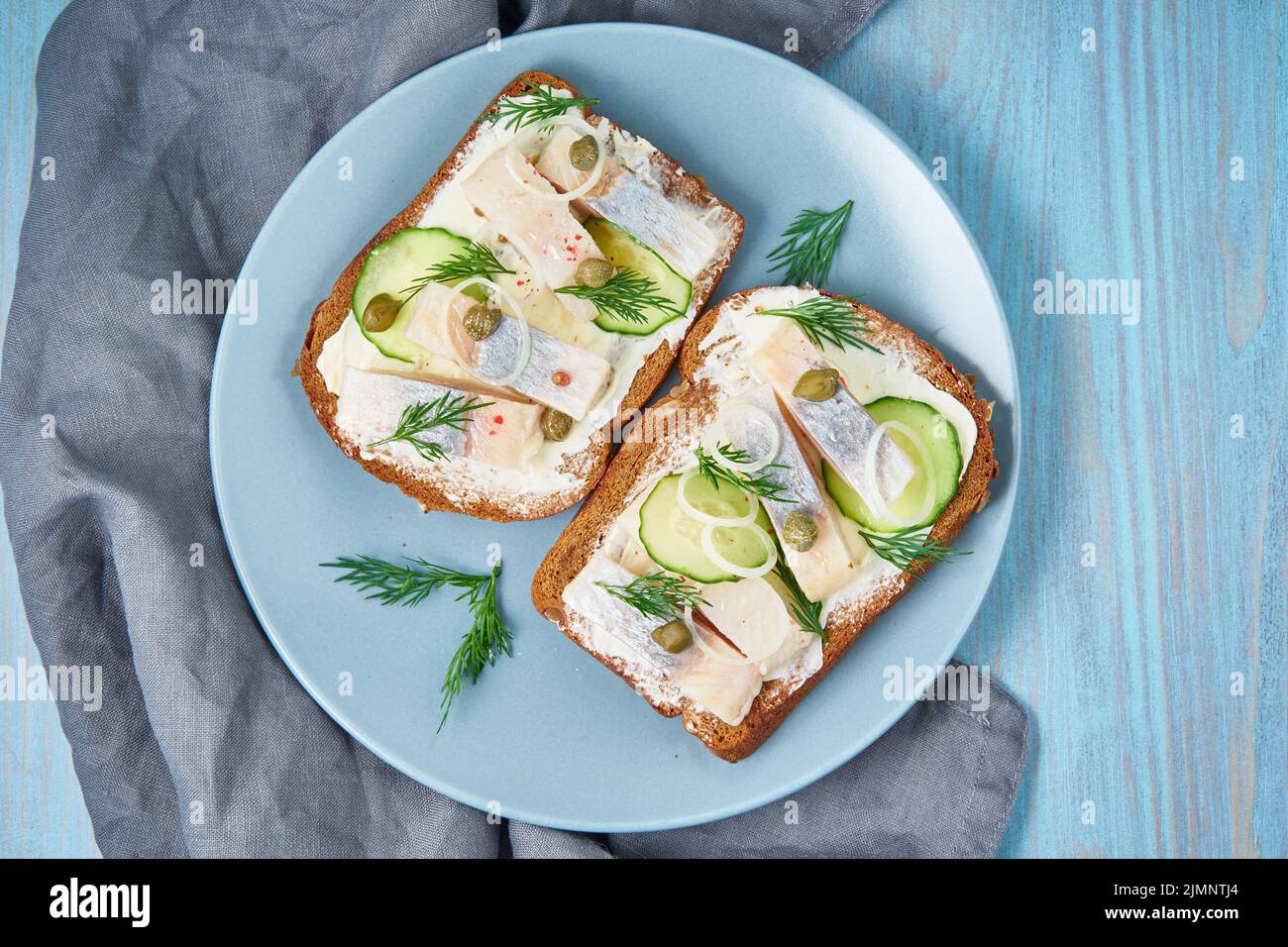 Herring smorrebrod - traditional Danish sandwiches. Black rye bread ...