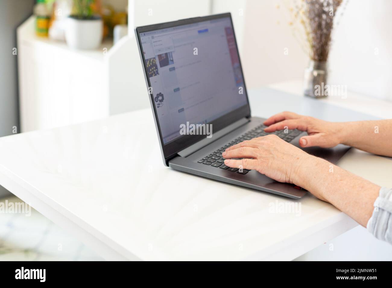 Old woman hands using computer Stock Photo - Alamy