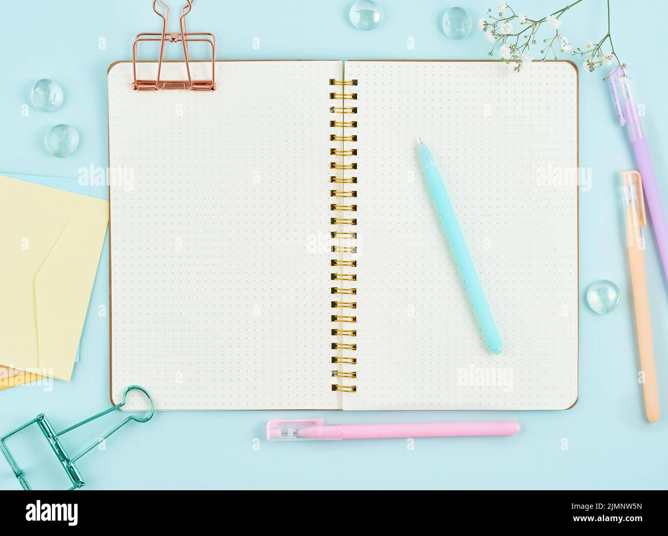 Blank notepad page in bullet journal on blue office desktop. Top view ...