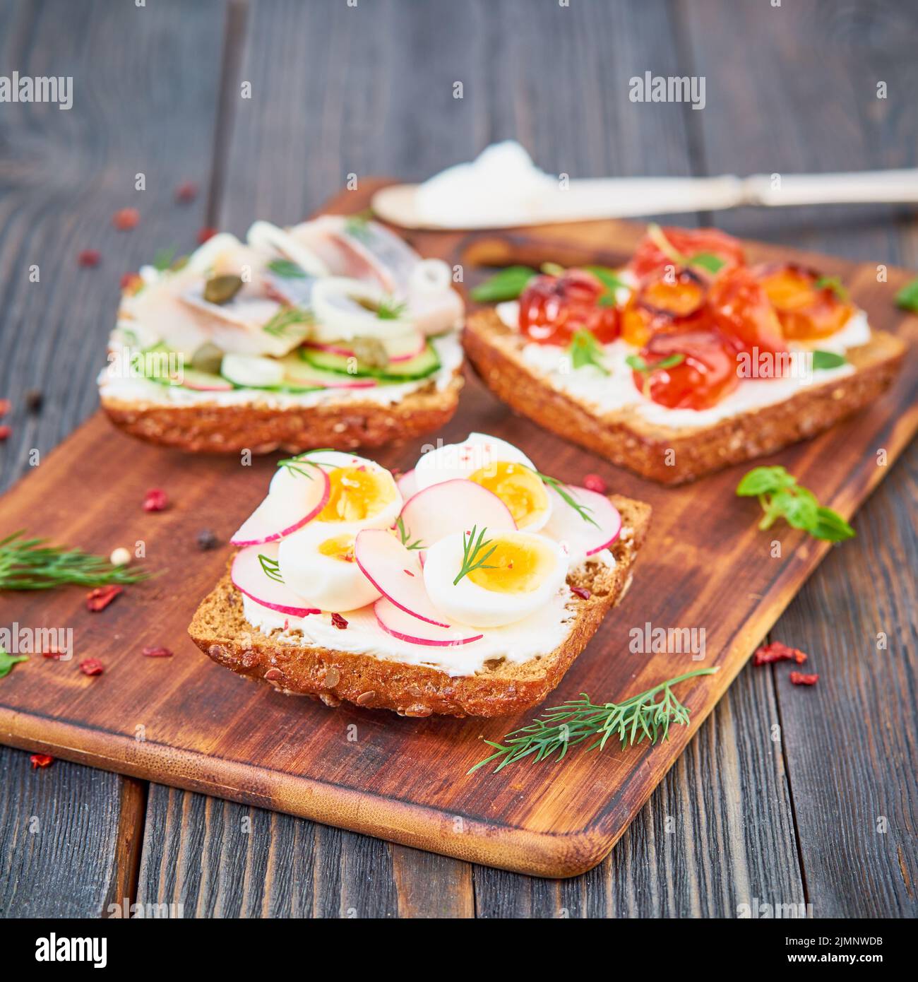 Smorrebrod - traditional Danish sandwiches. Black rye bread with fish Stock Photo - Alamy