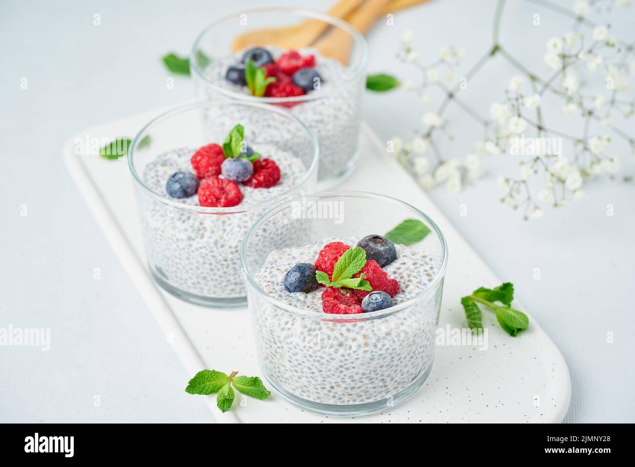 Chia pudding with fresh berries raspberries, blueberries. Three glass ...