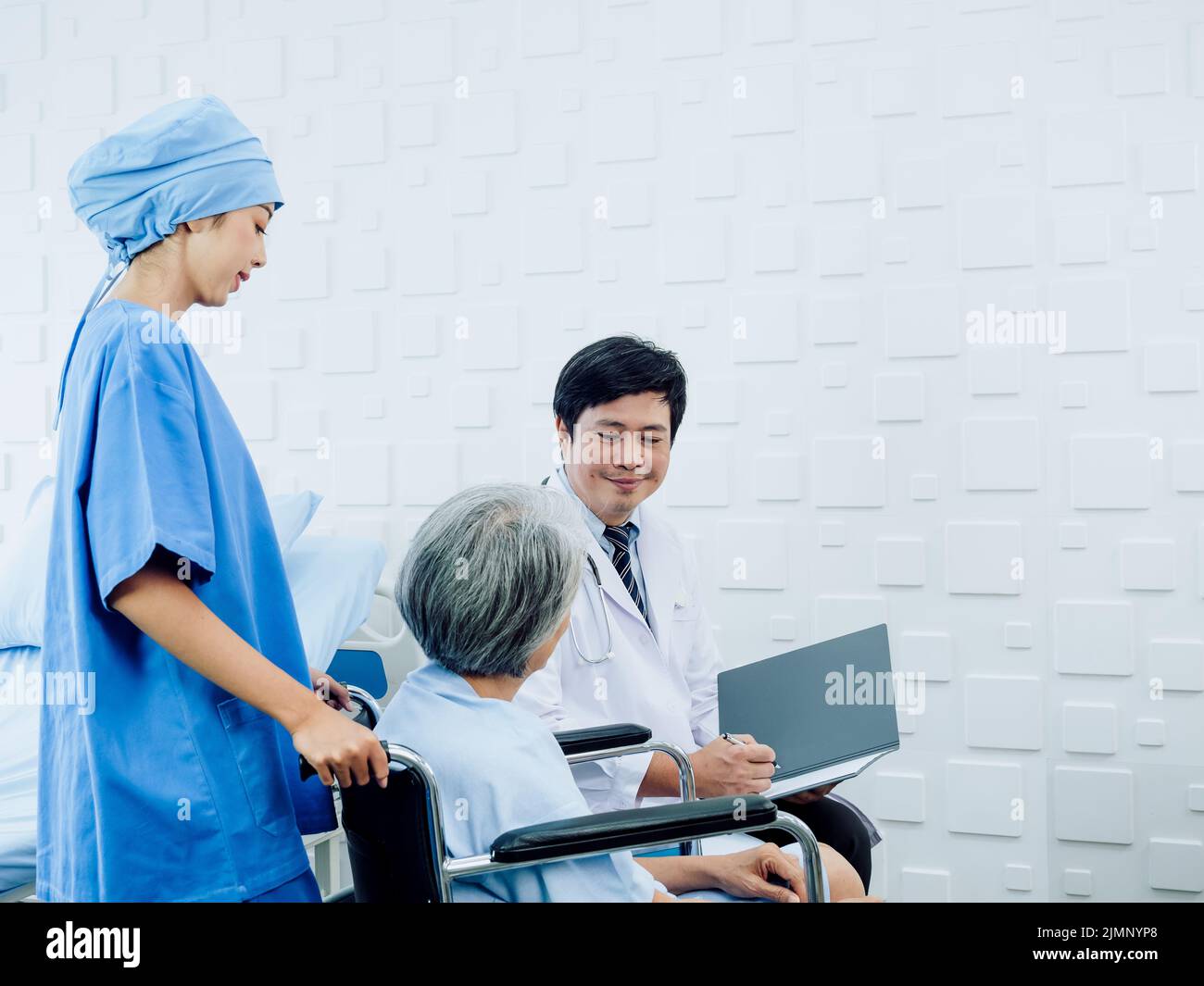 Male surgeon doctors and professional female nursing assistants take ...