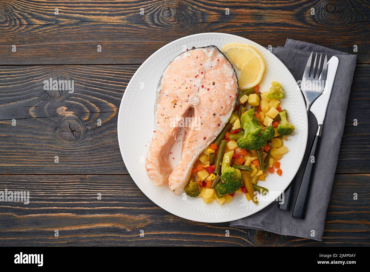Steam salmon and vegetables, healthy diet. White plate on rustic wooden ...