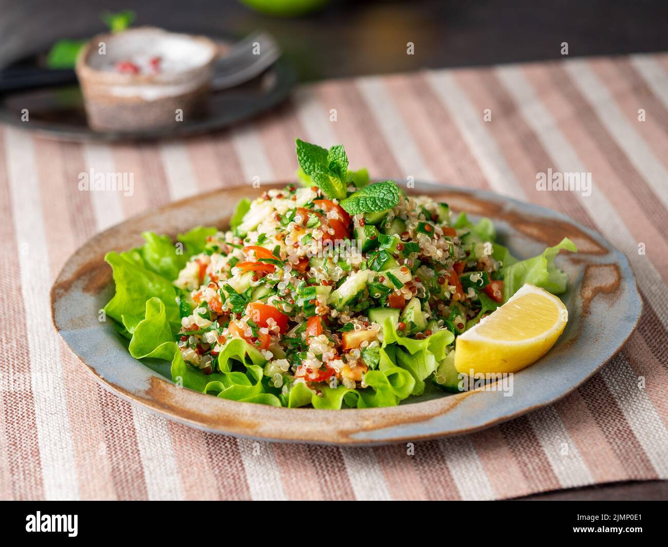 Tabbouleh salad with quinoa. Eastern food with vegetables mix, vegan ...