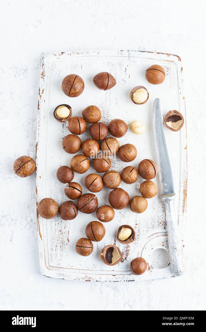Plate with almonds in endocarp, whole and chopped open nuts in bulk on ...