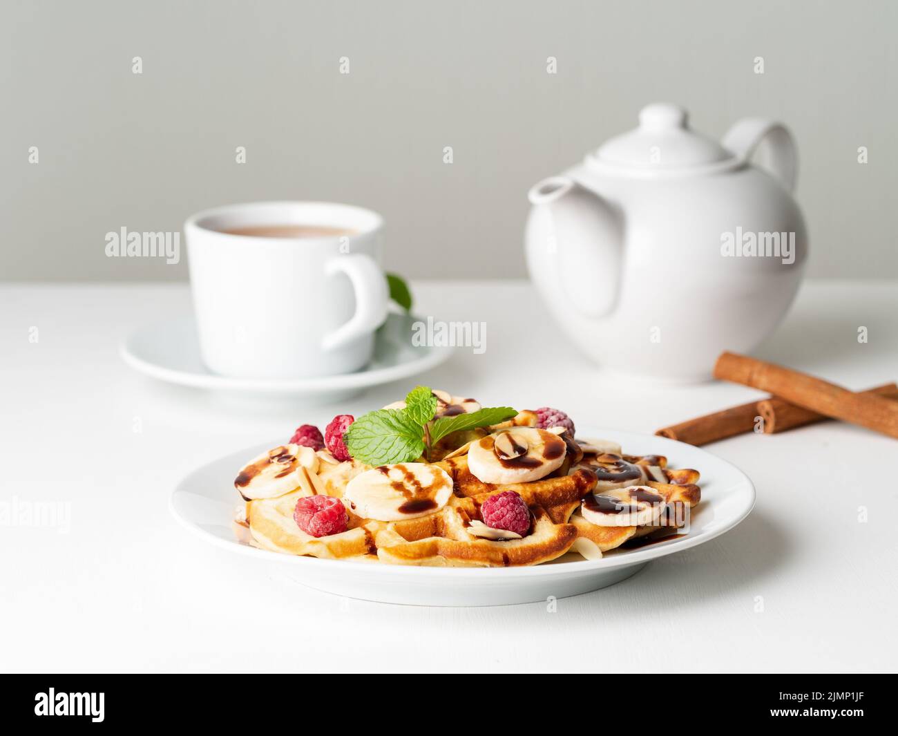 Belgian curd waffles with raspberries, banana, chocolate syrup ...