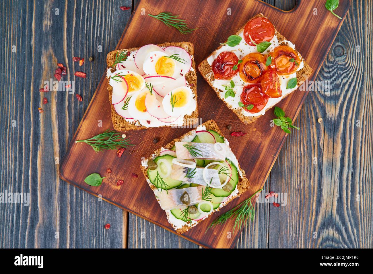 Smorrebrod - traditional Danish sandwiches. Black rye bread with fish ...