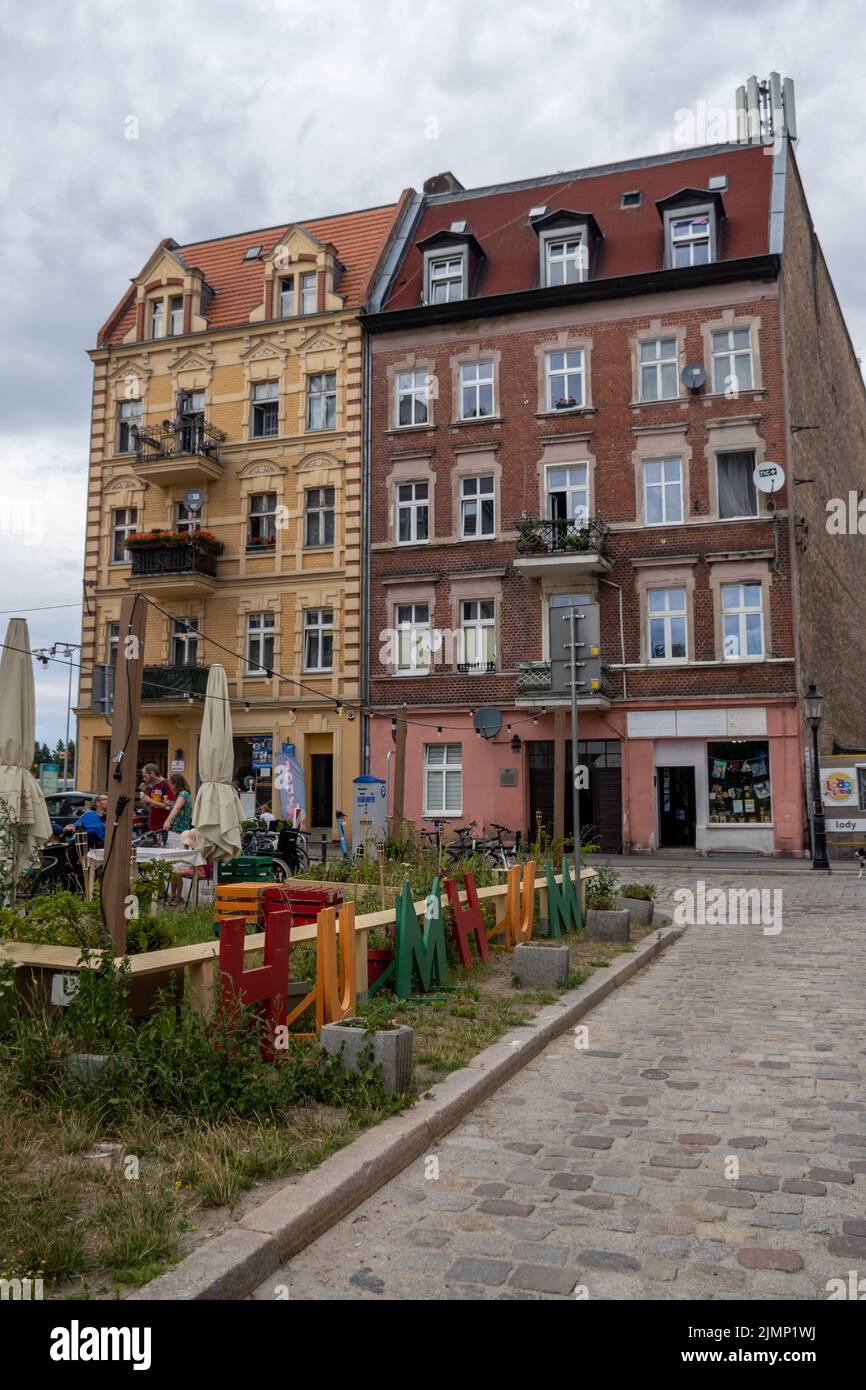 A vertical shot of a colorful residential building and restaurants on ...