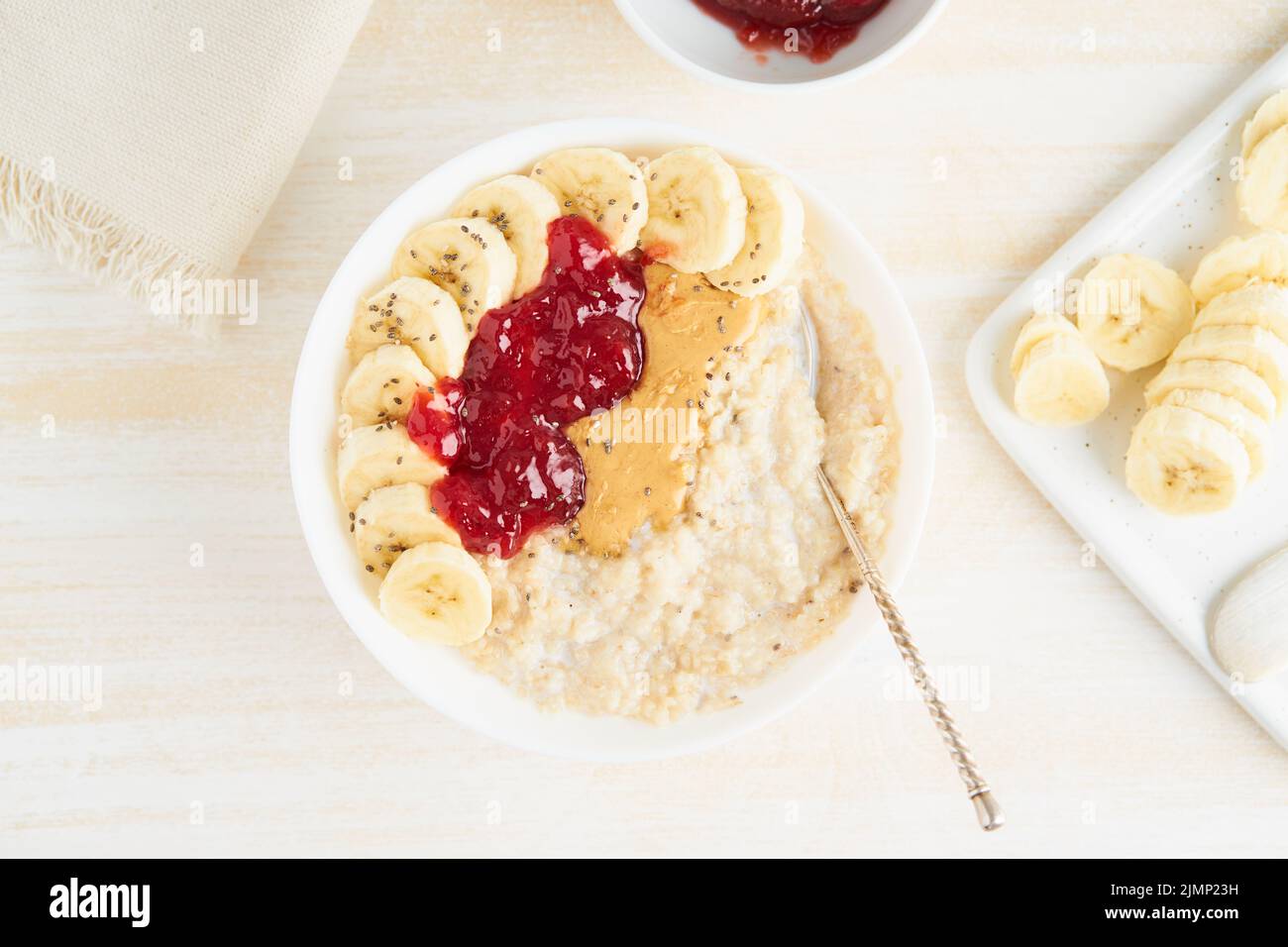 Oatmeal porridge, healthy vegan diet breakfast with strawberry jam ...