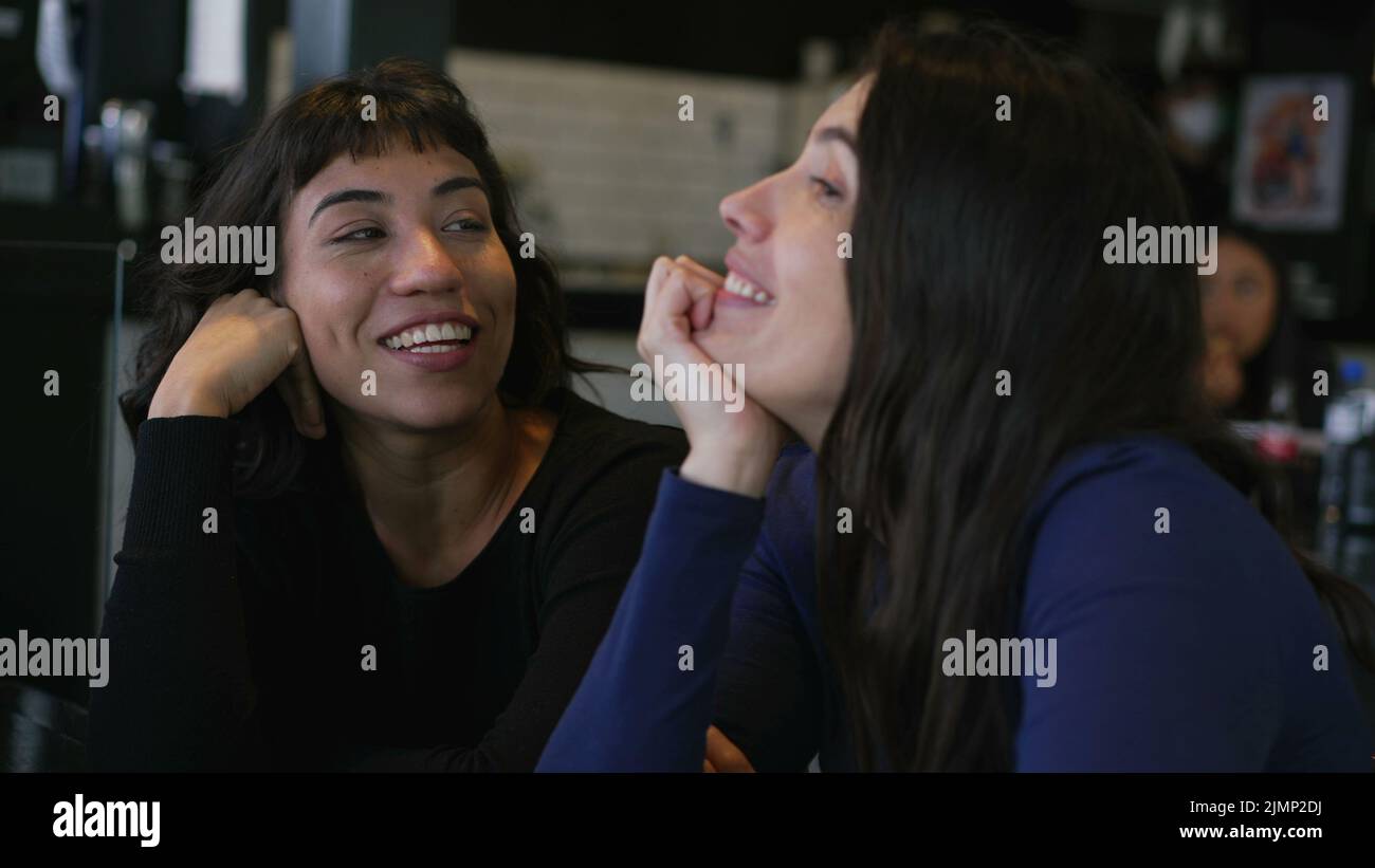 Happy women in conversation at cafe restaurant. Two people talking ...