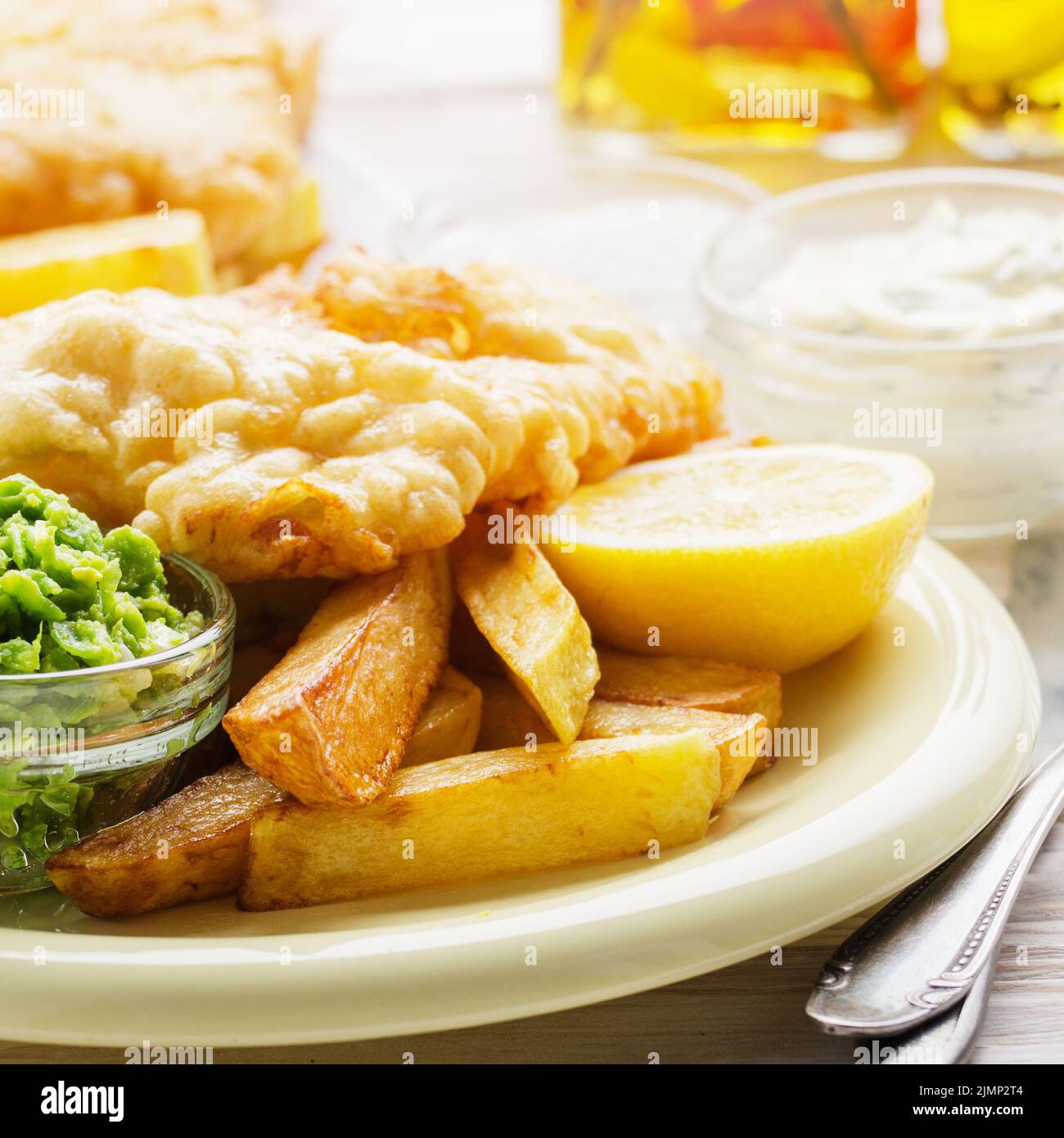 Traditional British street food fish and chips with tartar sauce and ...
