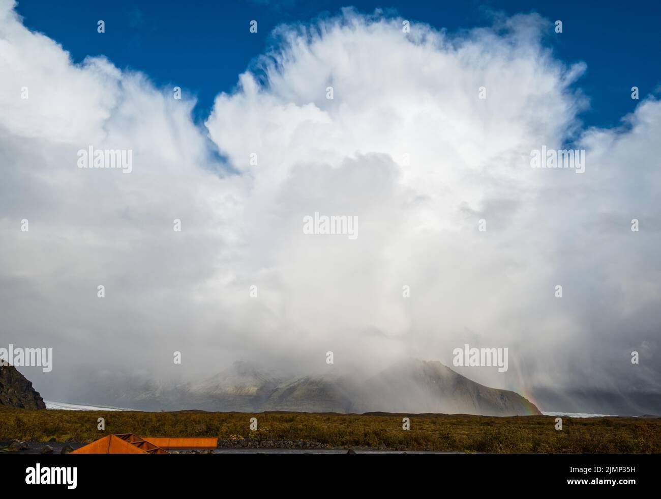 Mountain and rainbow view during auto trip in Iceland. Spectacular rain ...