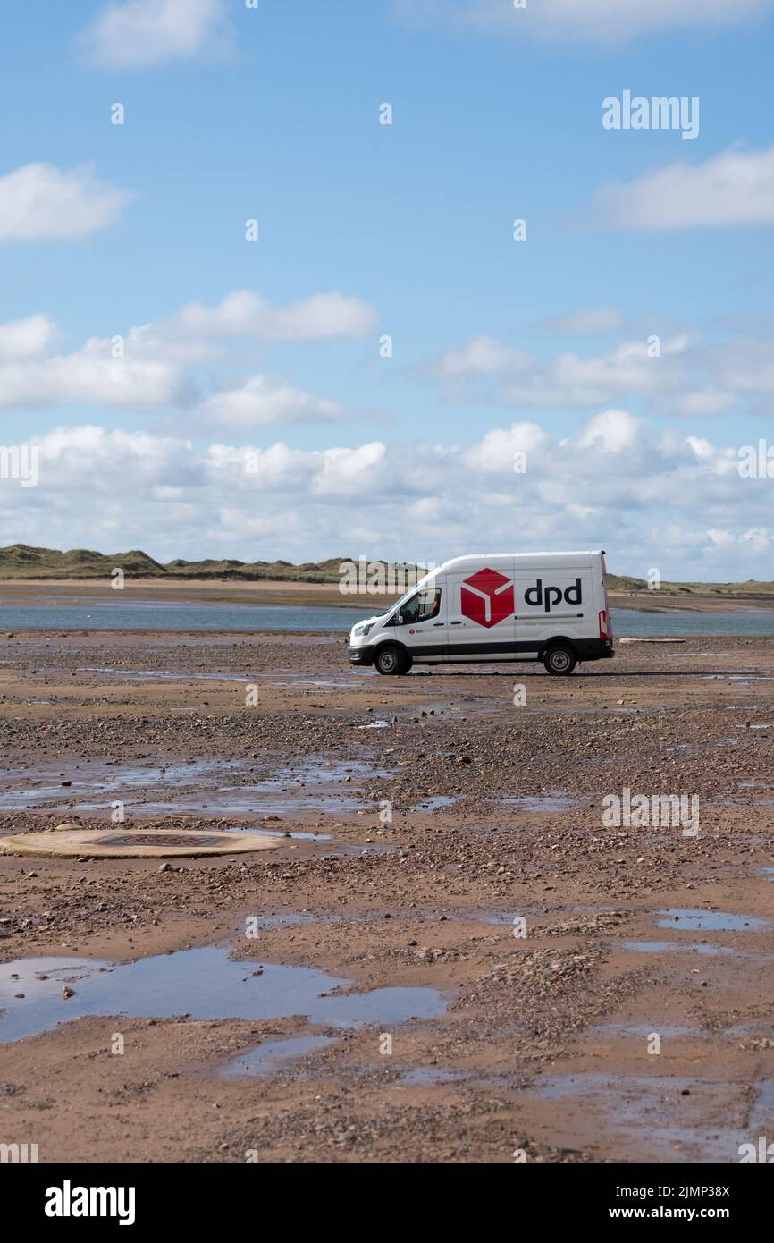 DPD delivery driver on beach, coastal part of Lake District Stock Photo ...