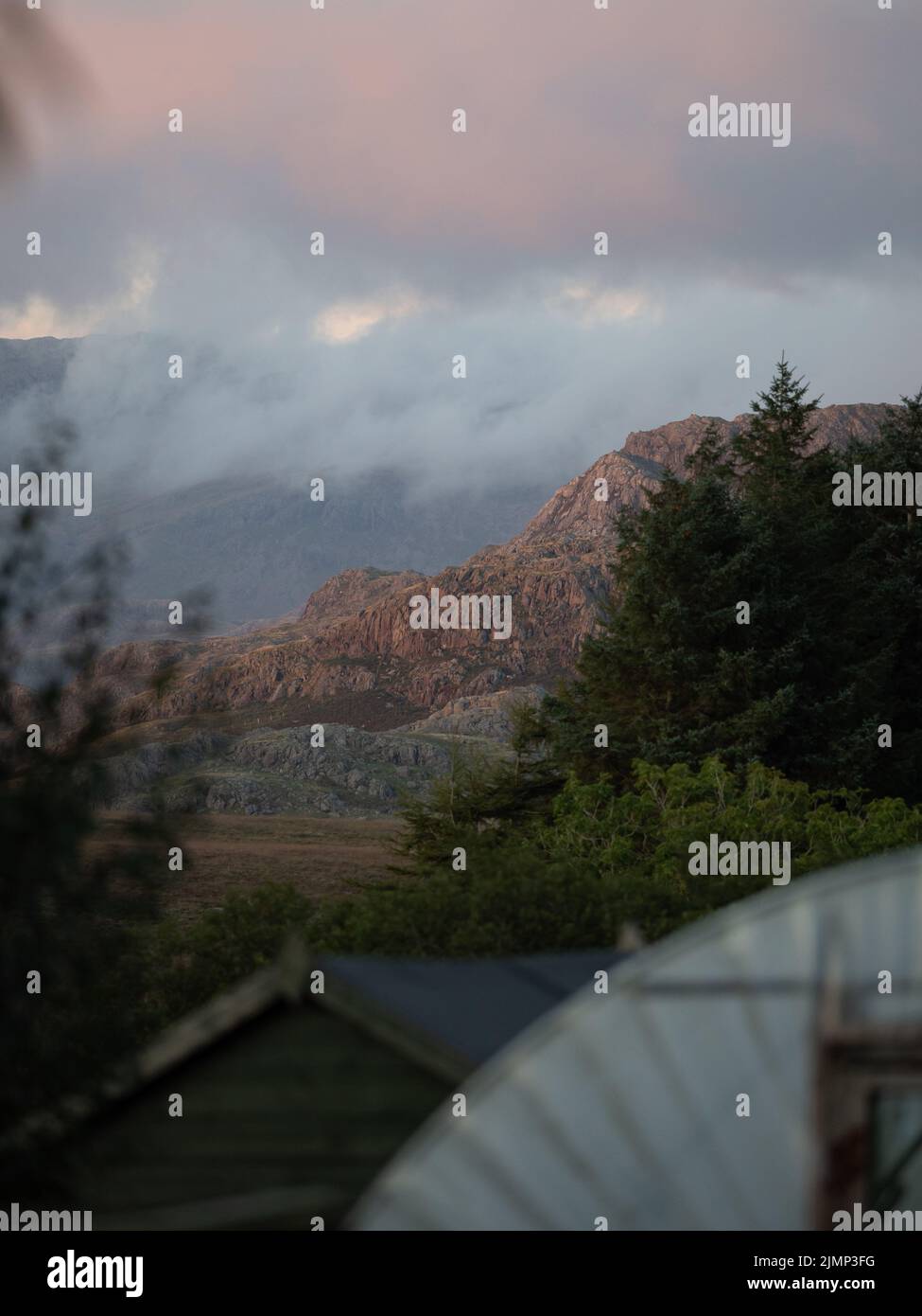 Lake District view, dusky pink clouds at sunset, greenhouse Stock Photo ...