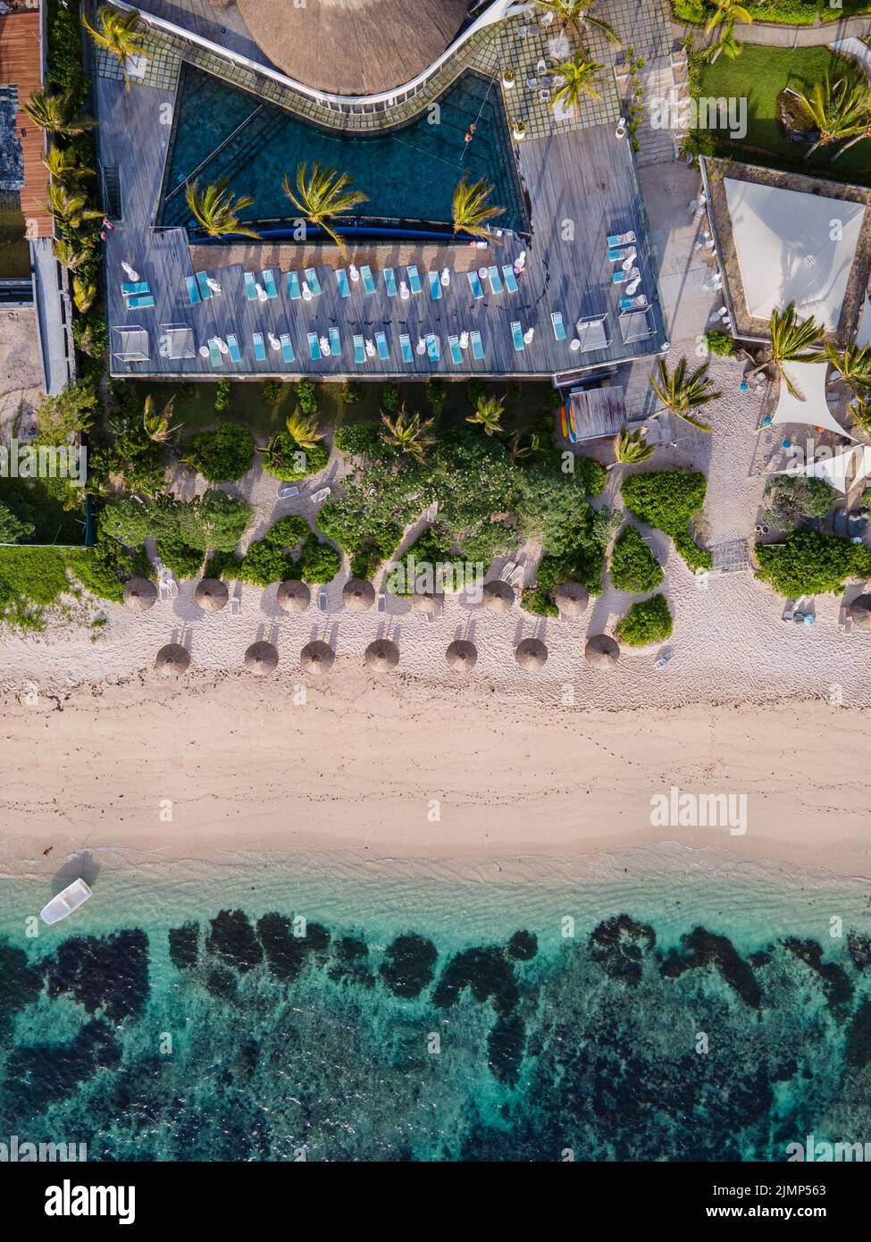 Drone aerial view of tropical swimming pool by a blue ocean Stock Photo ...