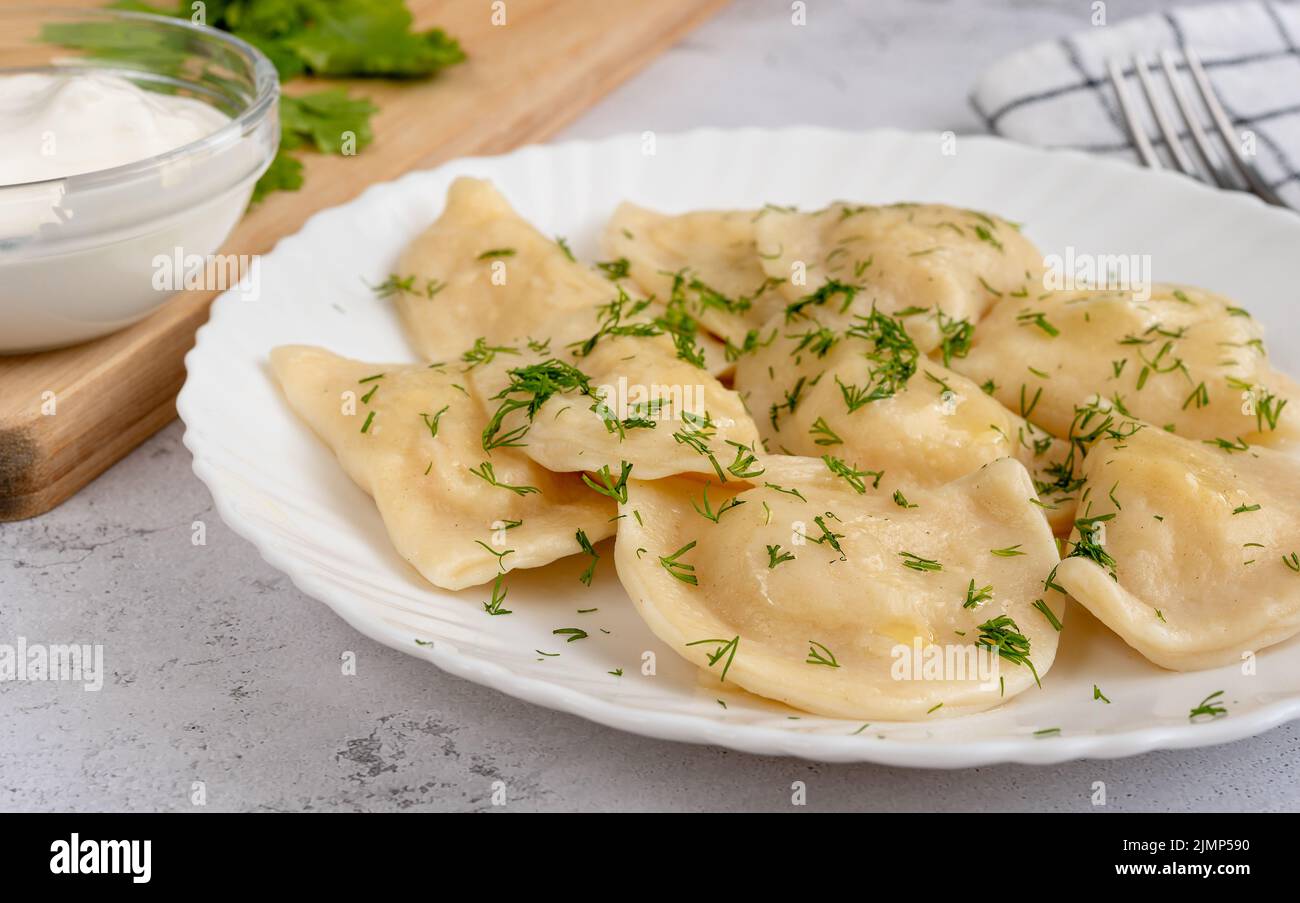Traditional dish of Slavic cuisine. Potato-filled varenyky on a white ...