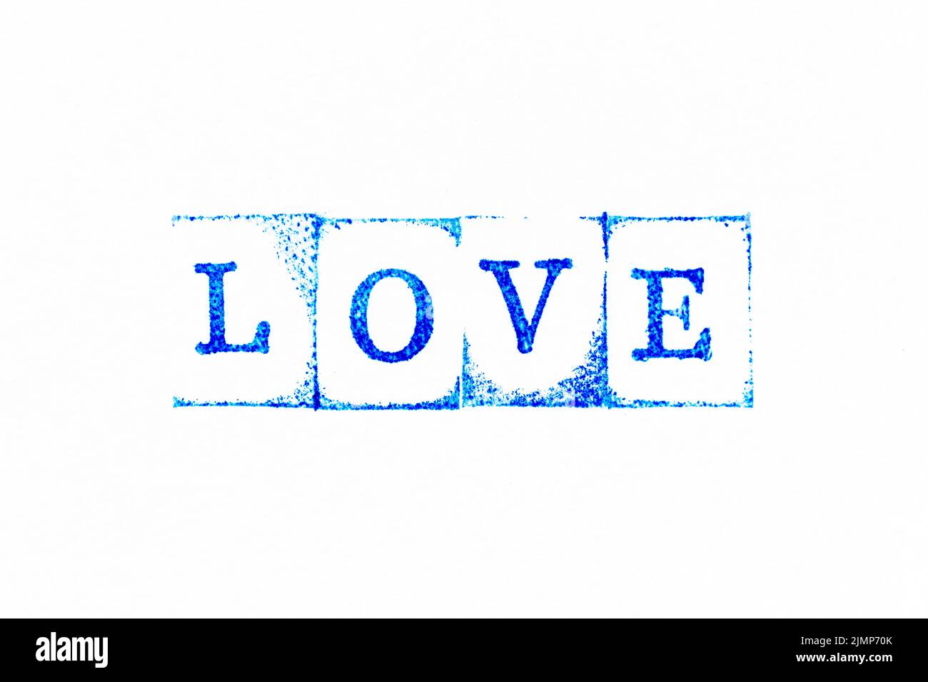 Blue color ink rubber stamp in word love on white paper background ...
