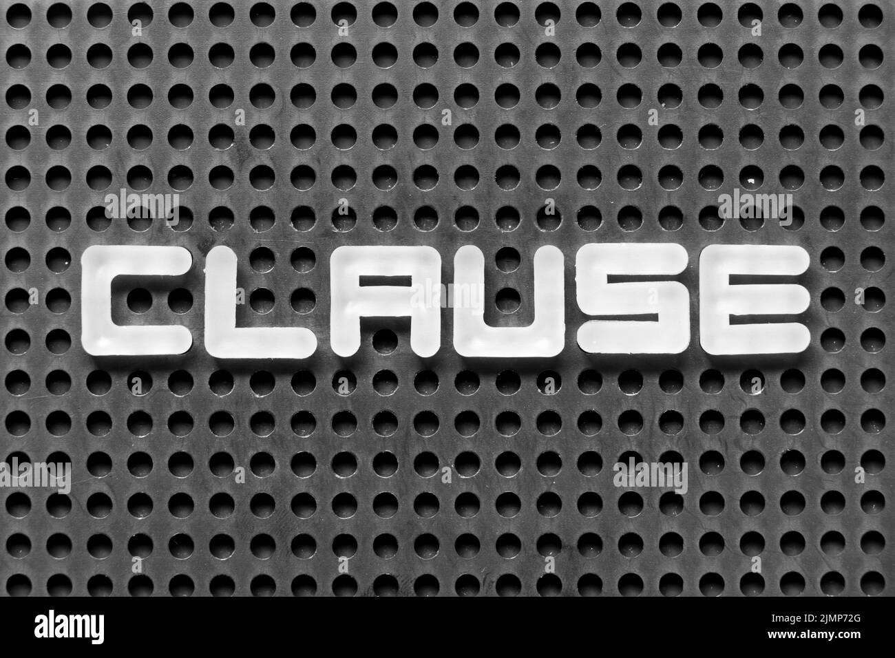 White alphabet letter in word clause on black pegboard background Stock ...