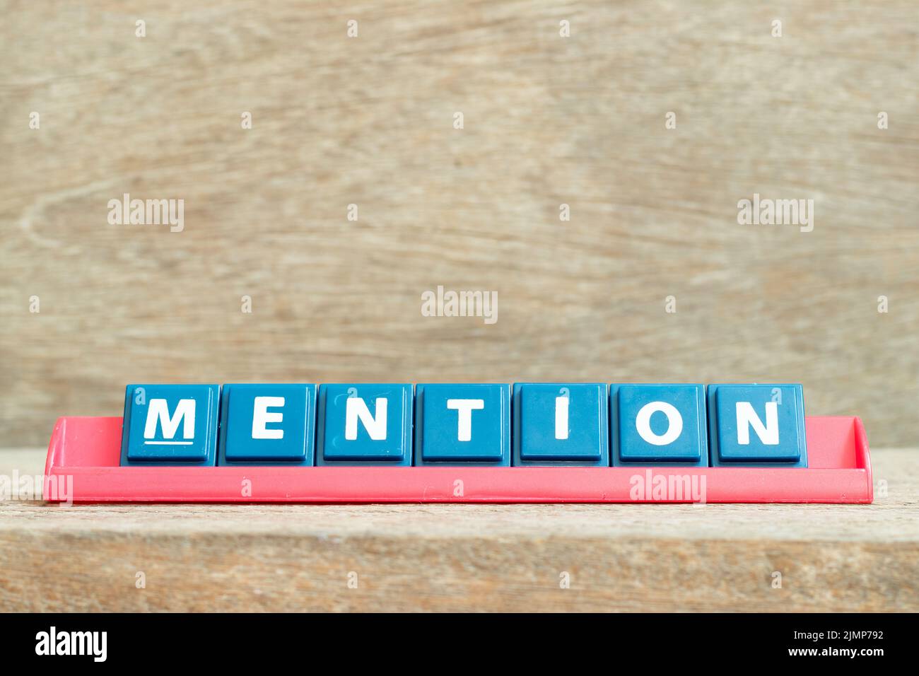 Tile alphabet letter with word mention in red color rack on wood ...