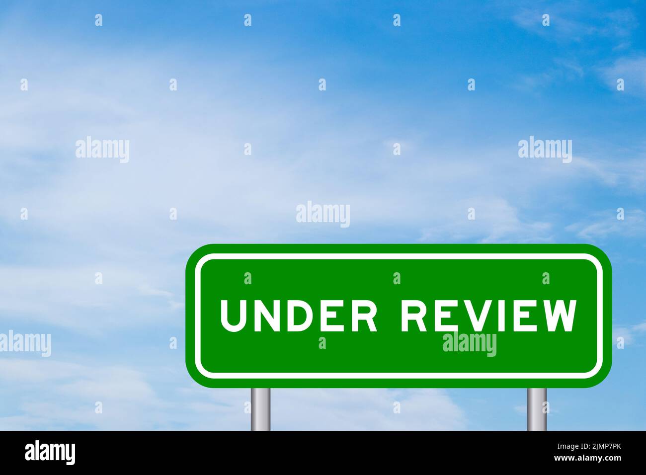 Green color transportation sign with word under review on blue sky with ...