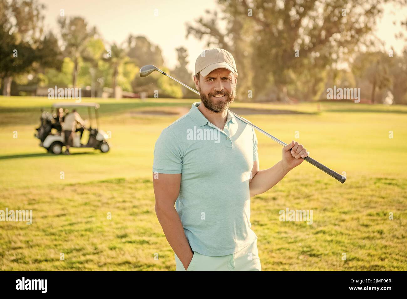 cheerful male golf player on professional course with green grass ...