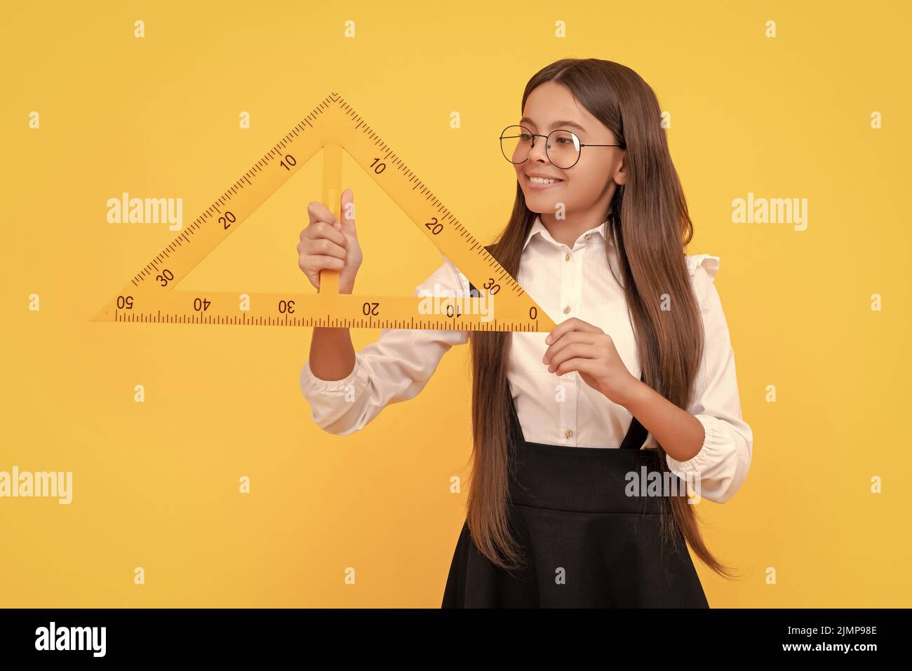 mathematics. happy teen girl hold triangle. back to school. algebra and ...