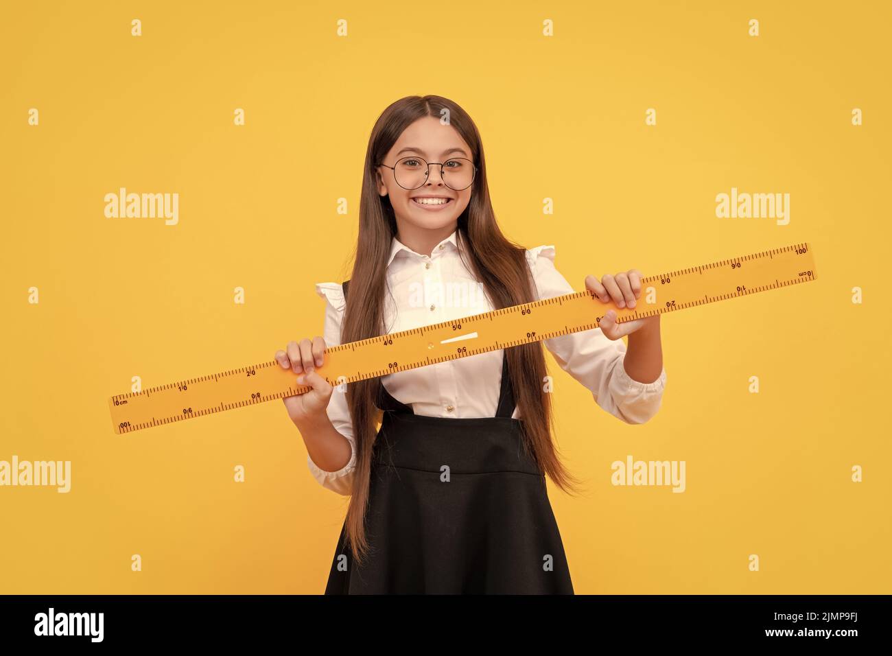 happy child in school uniform and glasses hold mathematics ruler for ...