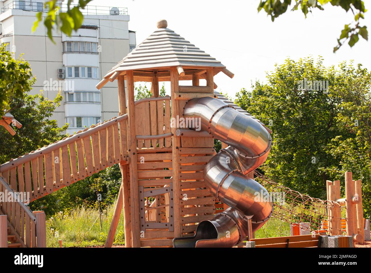 Modern children's playground for outdoor games, a slide pipe made of ...